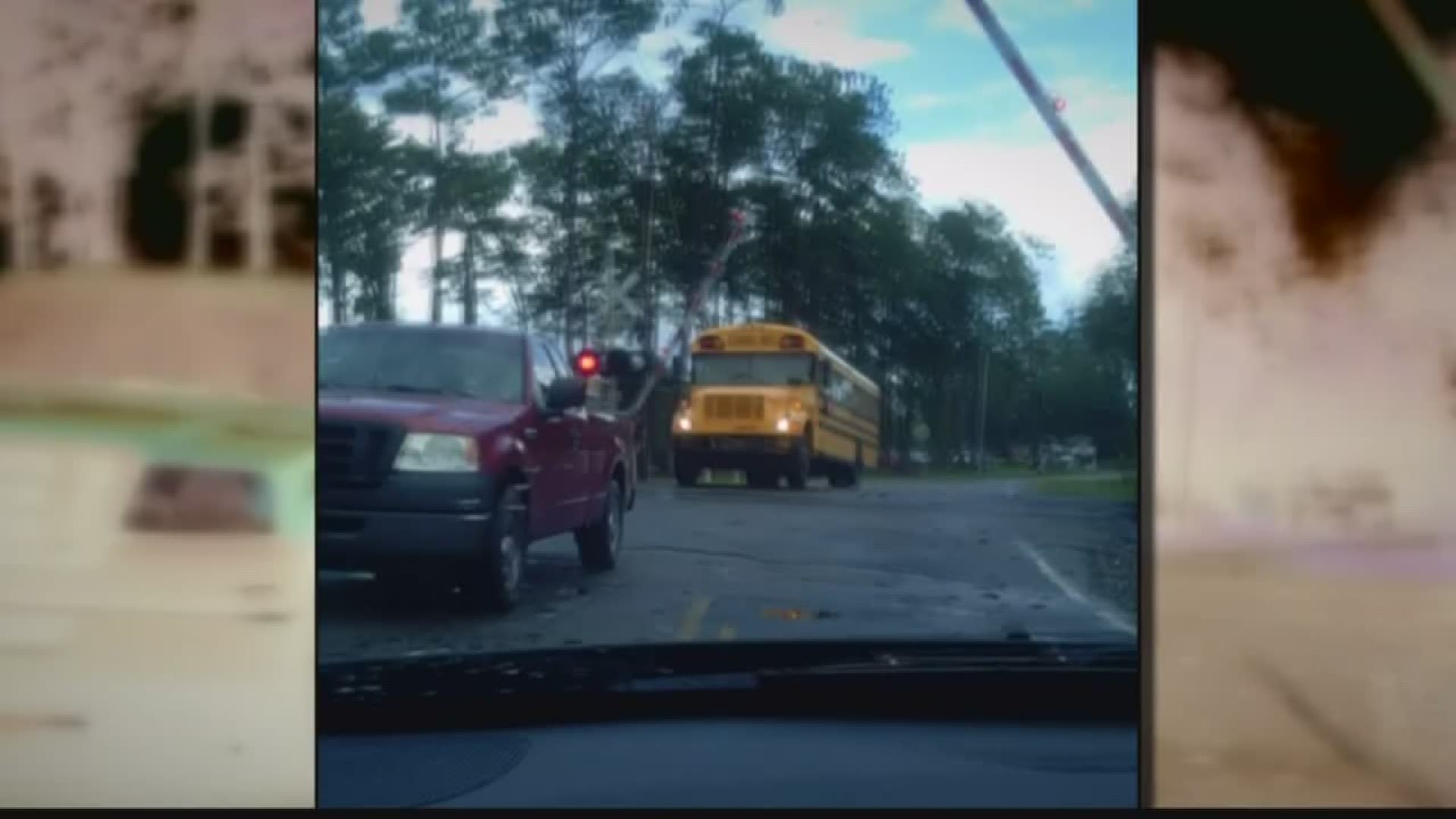 Folkston school bus driver plows through railroad tracks with red ...