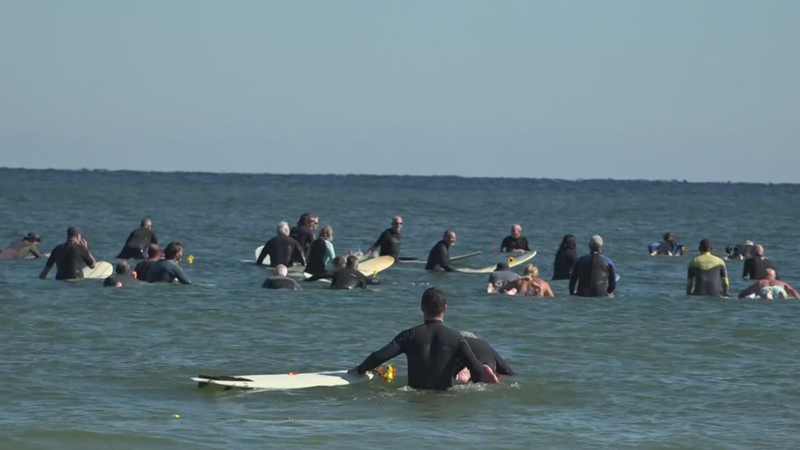 Surfing community honors 'legendary' surfer Joe Roland with 'paddle out ...