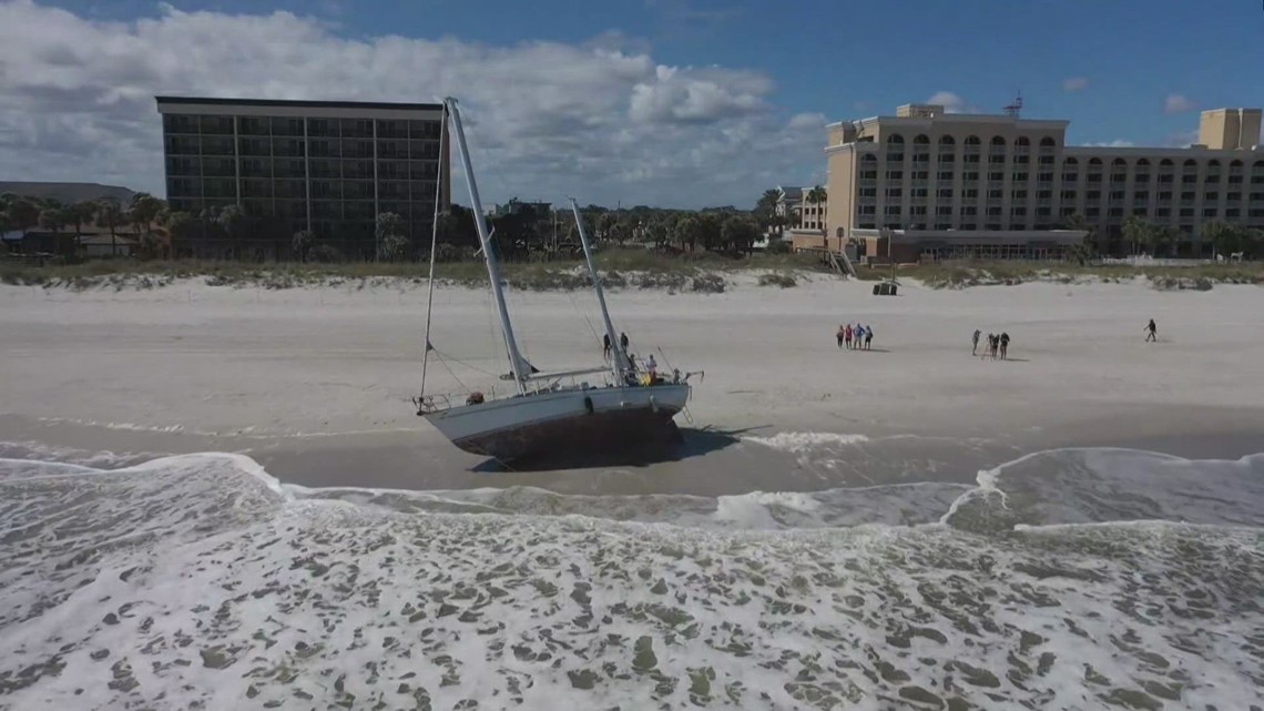 'I am tied to this ship': Man won't leave sailboat stranded on ...