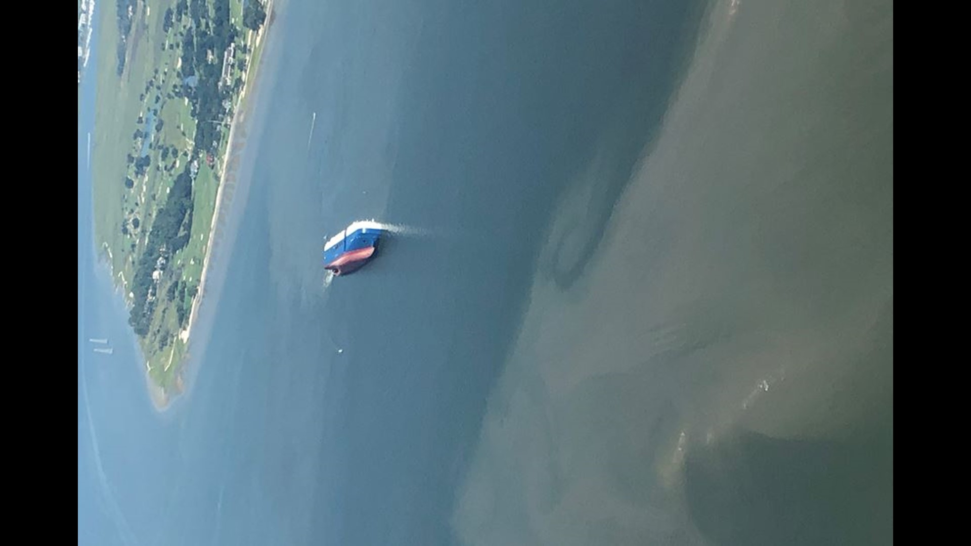 PHOTOS: Aerial view of overturned cargo ship leaking fluid into the St ...