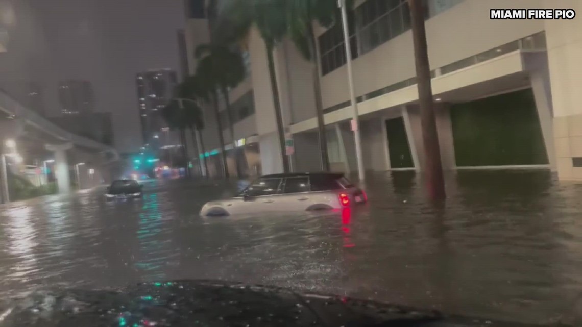 Miami drivers get stuck in flood waters, climb out sunroofs ...